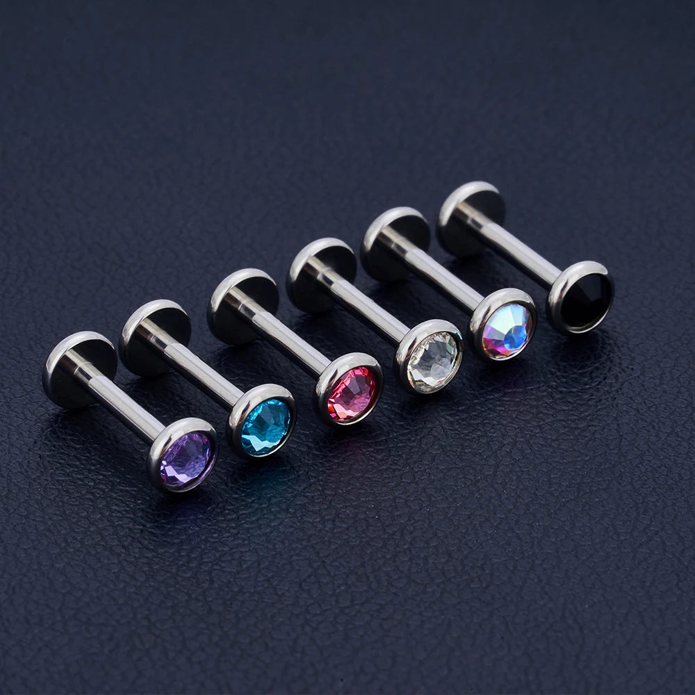 Diamond Monroe piercing with a clear pink purple black blue stone tita ...