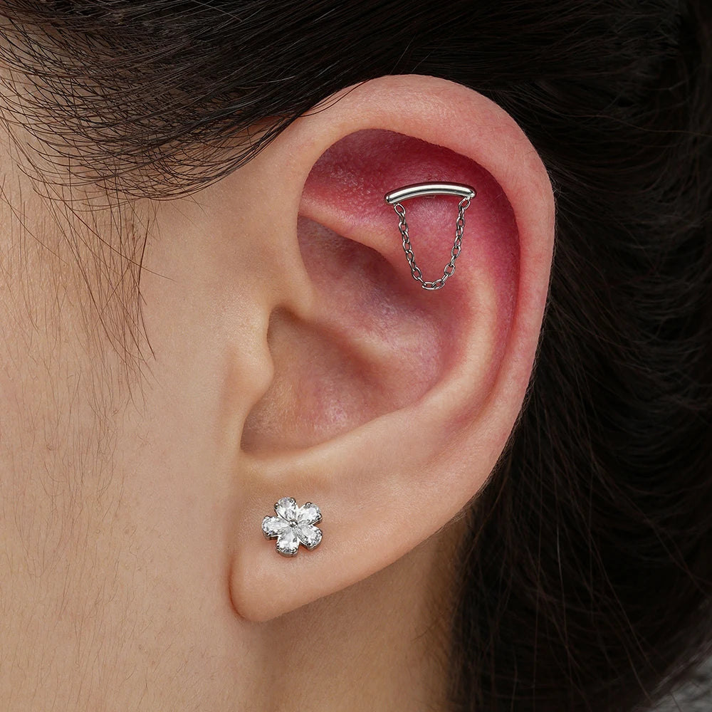 Flat piercing stud in a flower shape with clear cz stones titanium lab ...