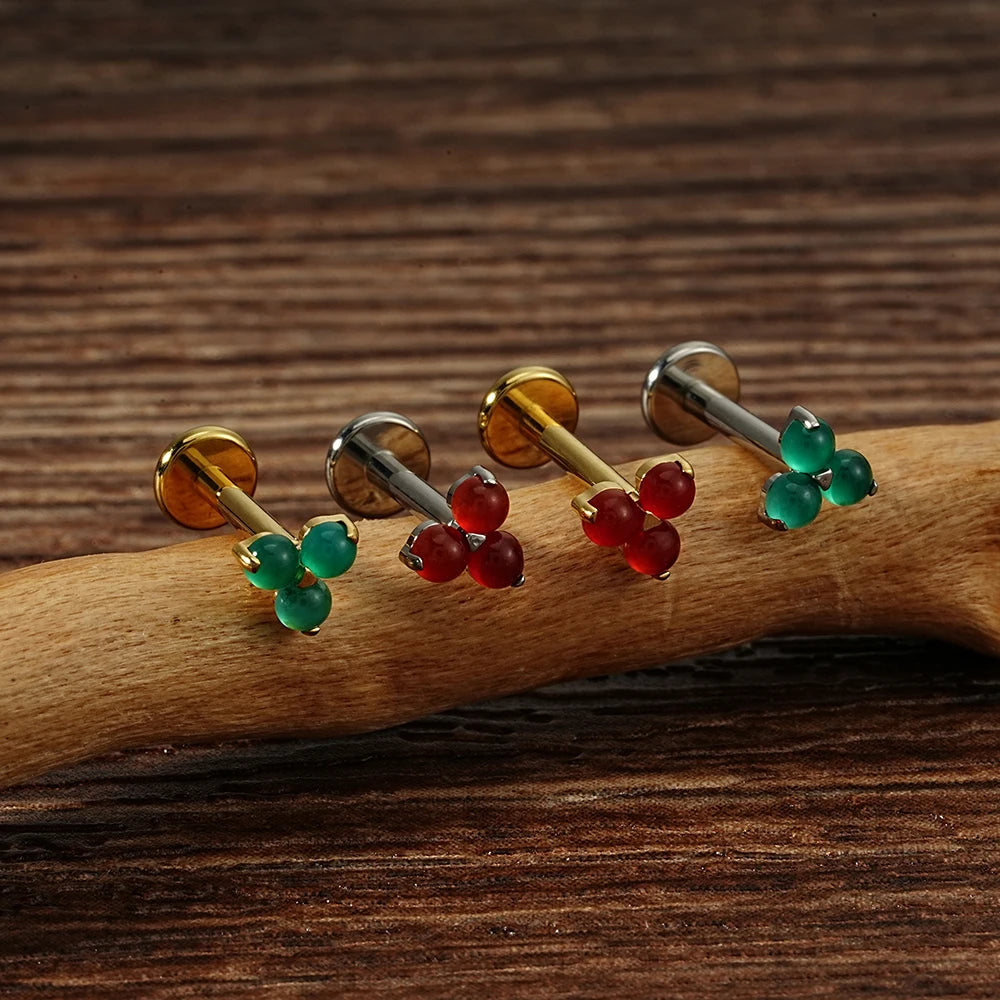 Cute Monroe piercing with natural gemstones red and green stones in si ...